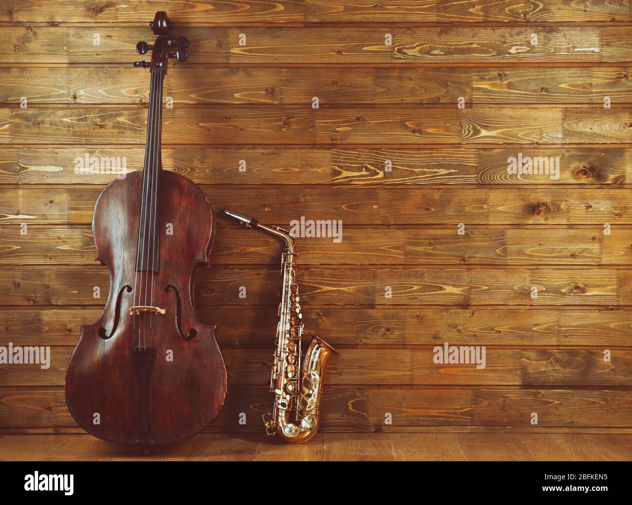 Musical instruments on wooden planks background Stock Photo - Alamy