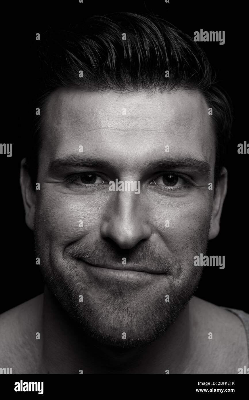 Man with a mischievous look in black and white Stock Photo - Alamy