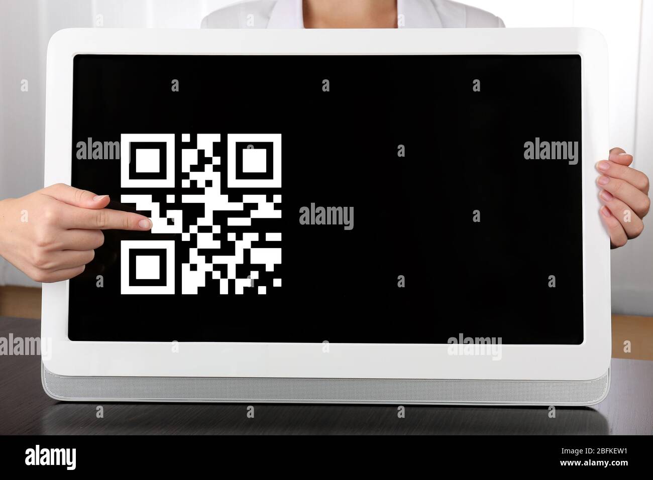 Hands holding tablet PC with QR code on screen Stock Photo - Alamy