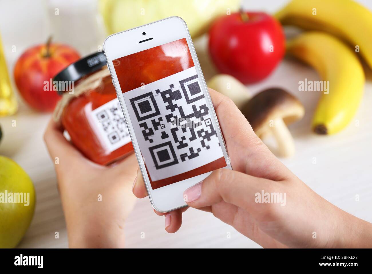 Woman scanning voucher code with mobile phone close up Stock Photo - Alamy