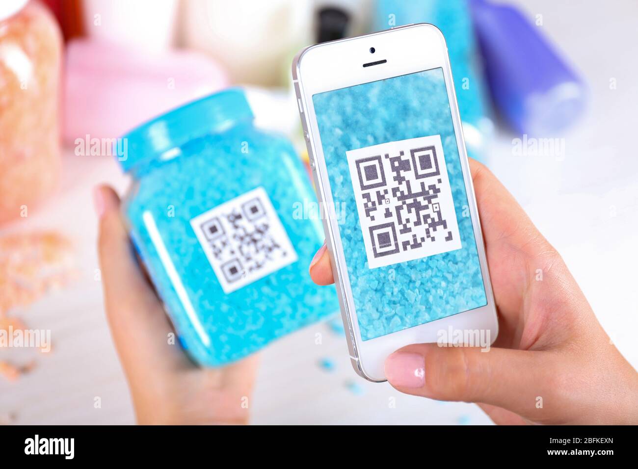 Woman scanning voucher code with mobile phone close up Stock Photo - Alamy