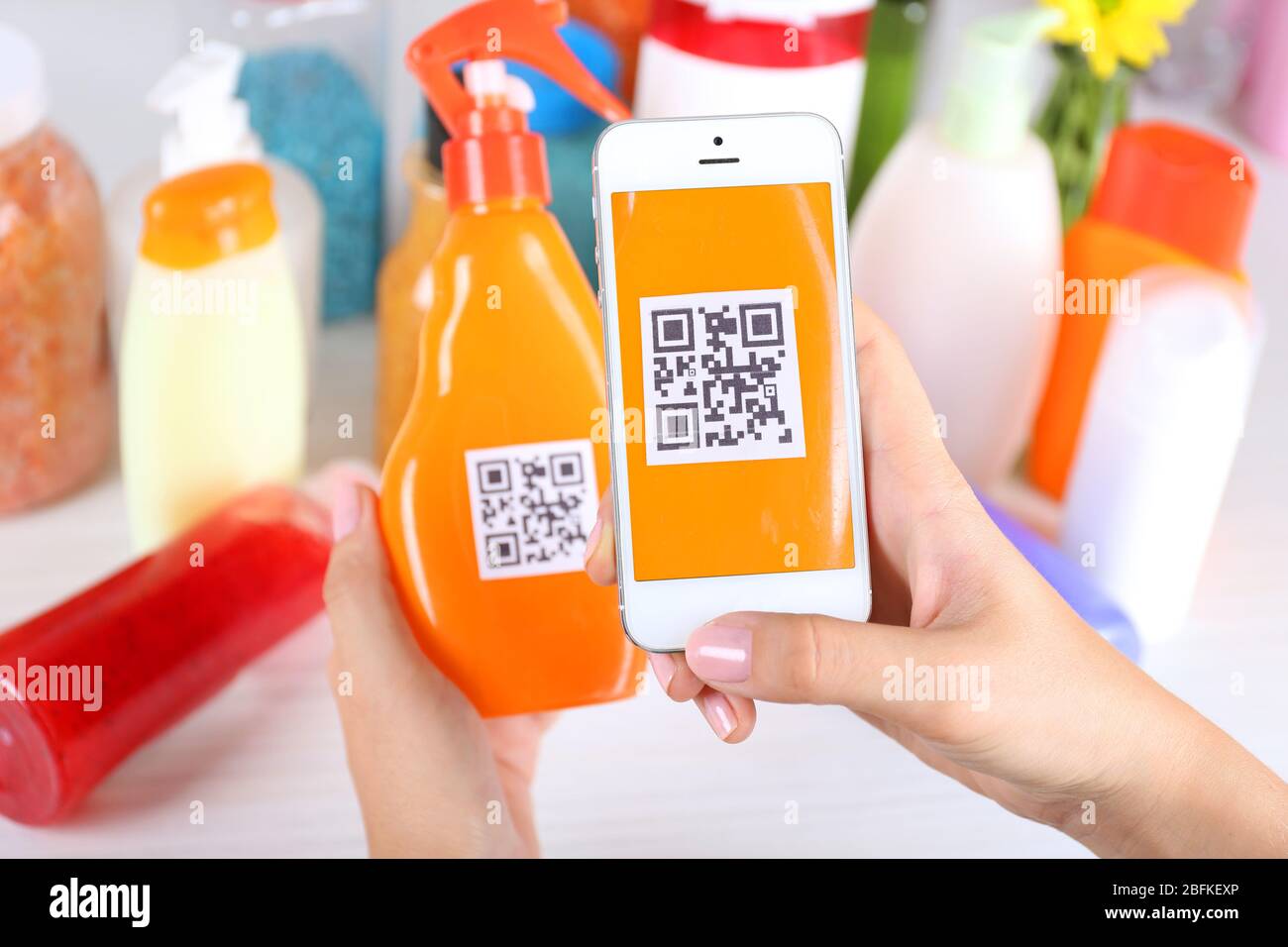 Woman scanning voucher code with mobile phone close up Stock Photo - Alamy
