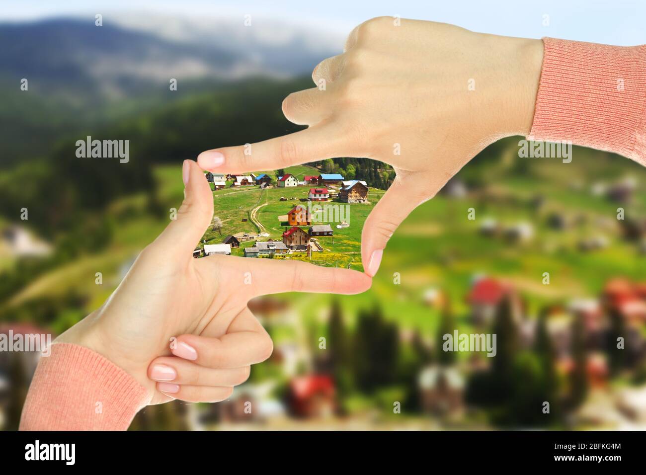 Woman holds hands in the shape of a frame on nature background Stock ...