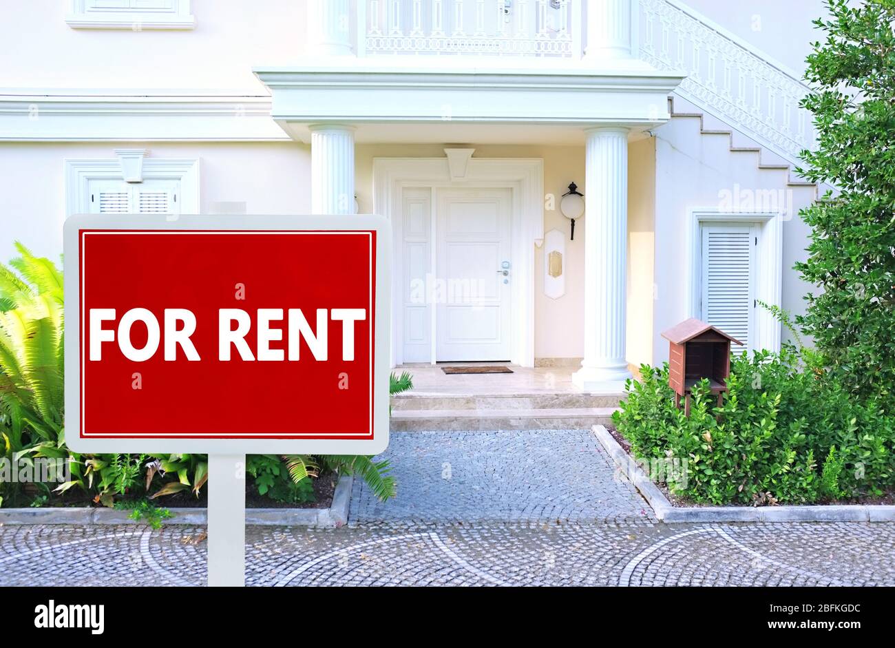 Real estate sign in front of new house for rent Stock Photo - Alamy