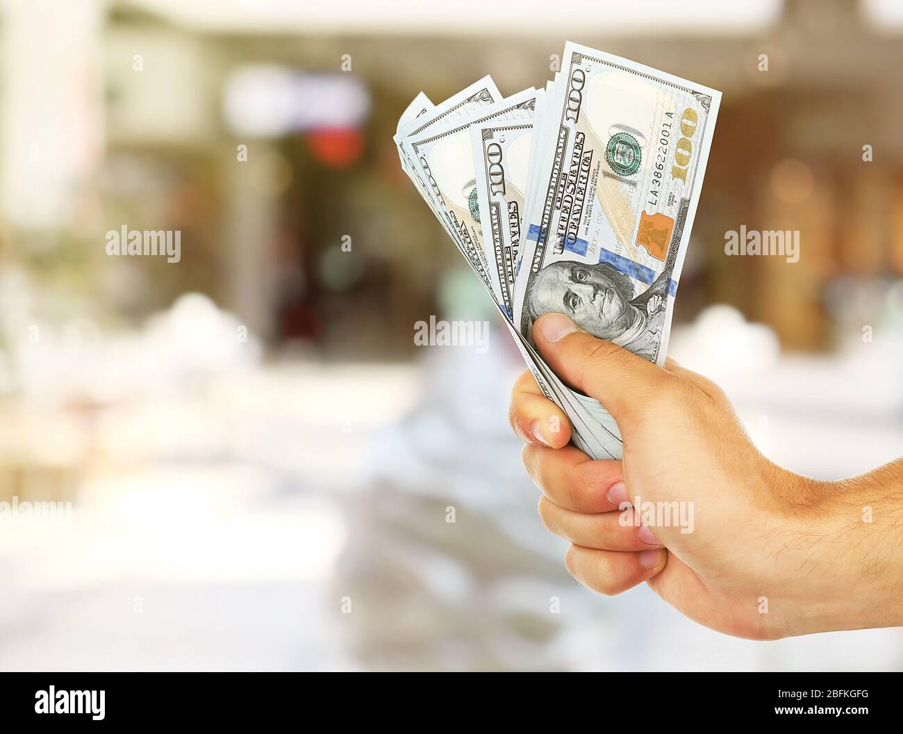 Female hand holding dollars Stock Photo - Alamy