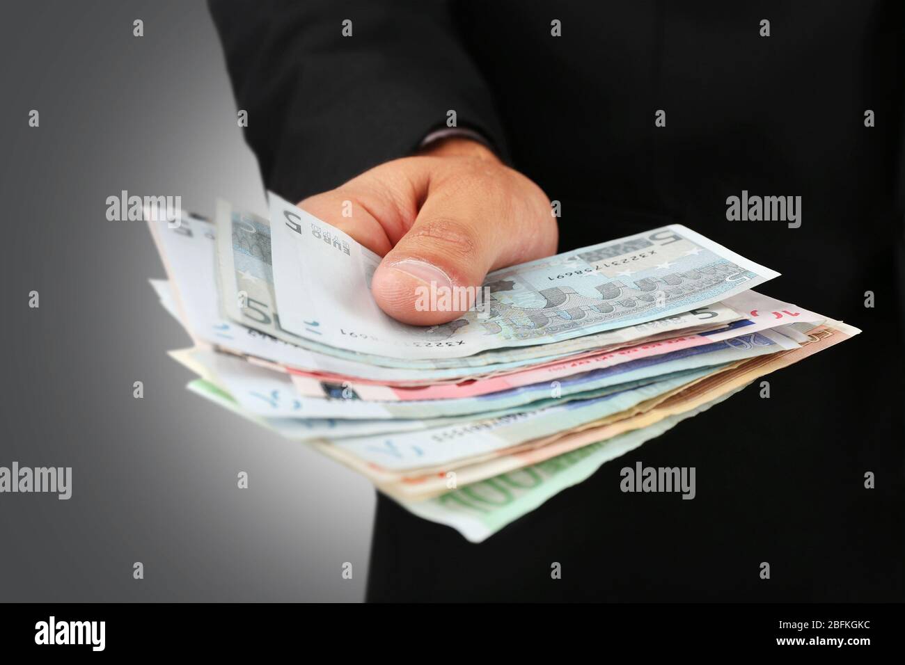 Hand euro on grey hi-res stock photography and images - Alamy