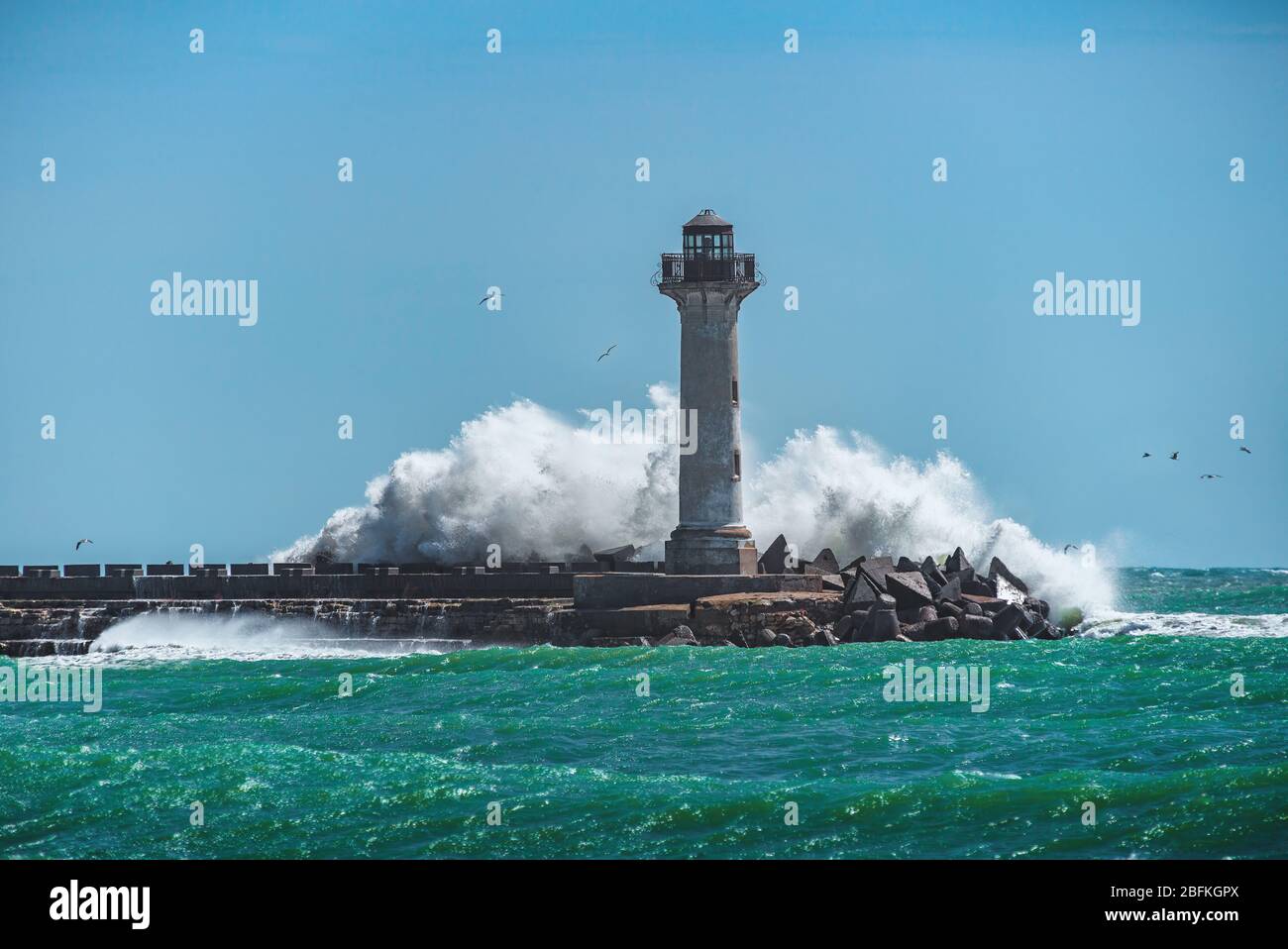 Waves crashing on Lighthouse Stock Photo - Alamy