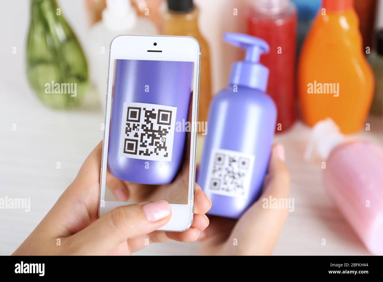 Woman scanning voucher code with mobile phone close up Stock Photo - Alamy