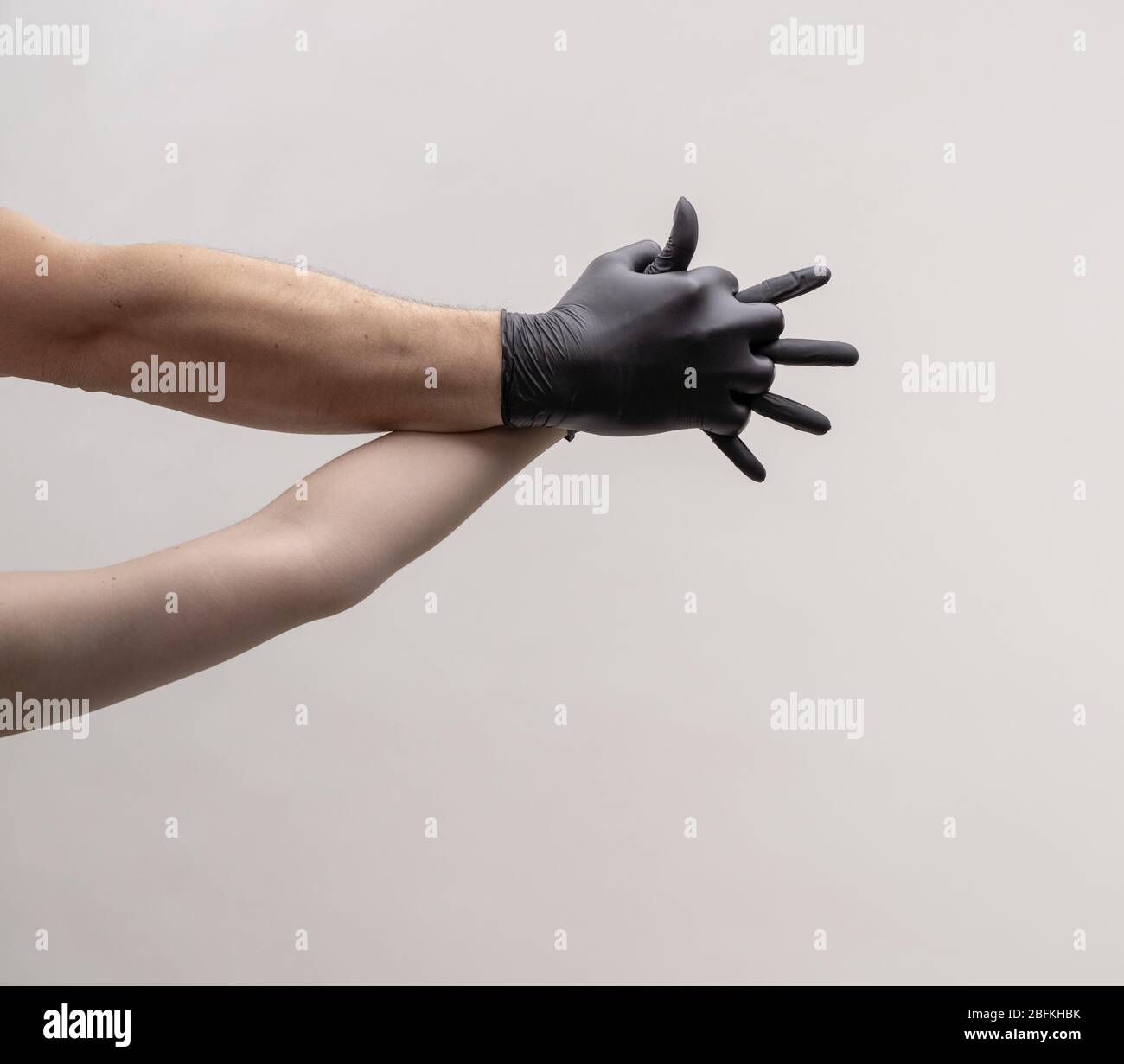 Male and female hand in black gloves. Hold each other Stock Photo - Alamy