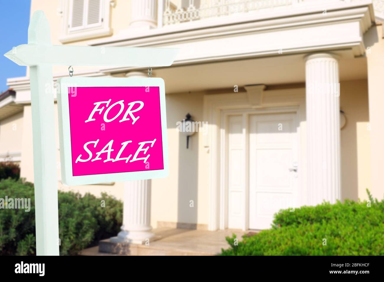 Real estate sign in front of new house for sale Stock Photo - Alamy