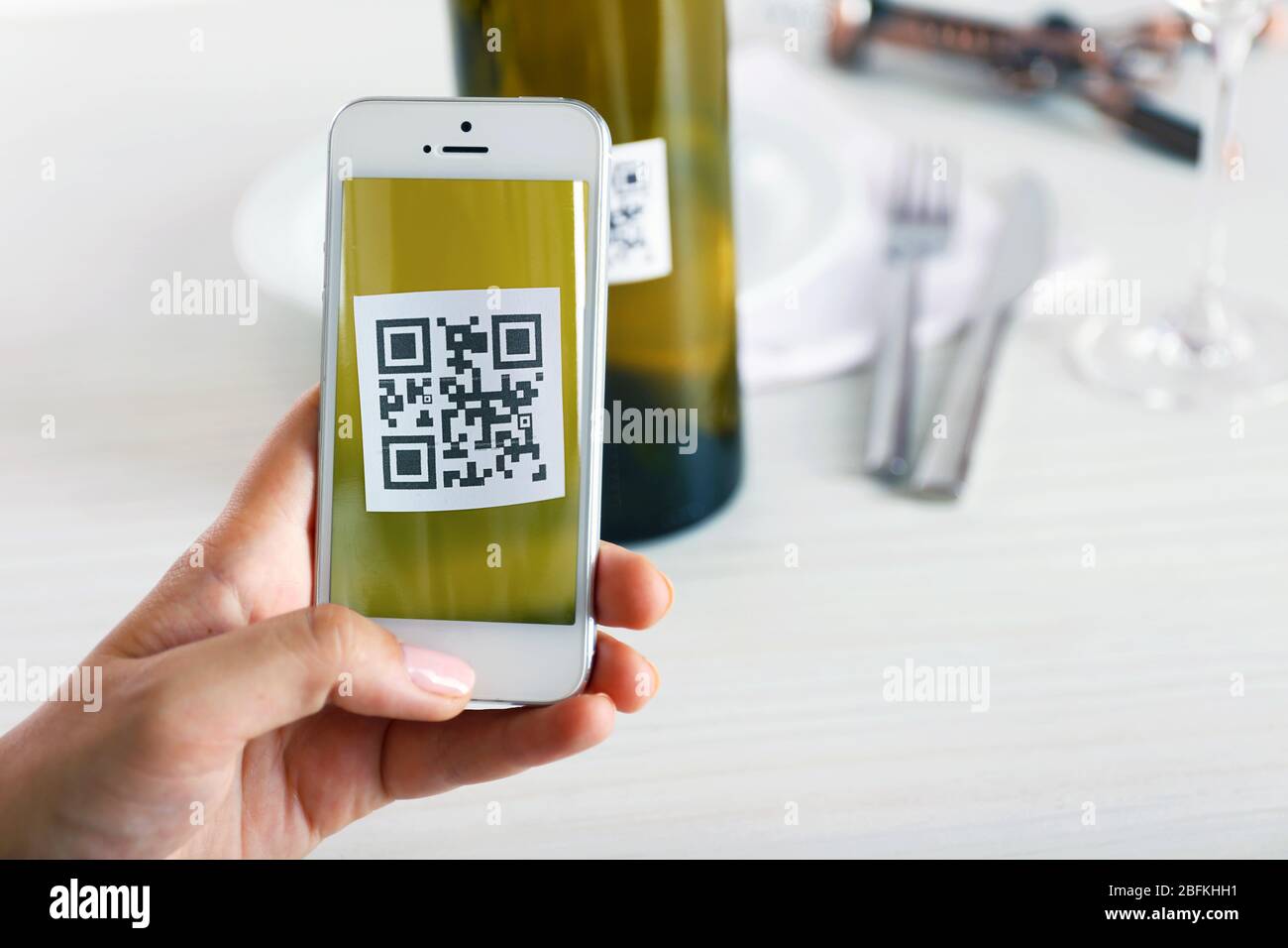 Woman scanning voucher code with mobile phone close up Stock Photo - Alamy