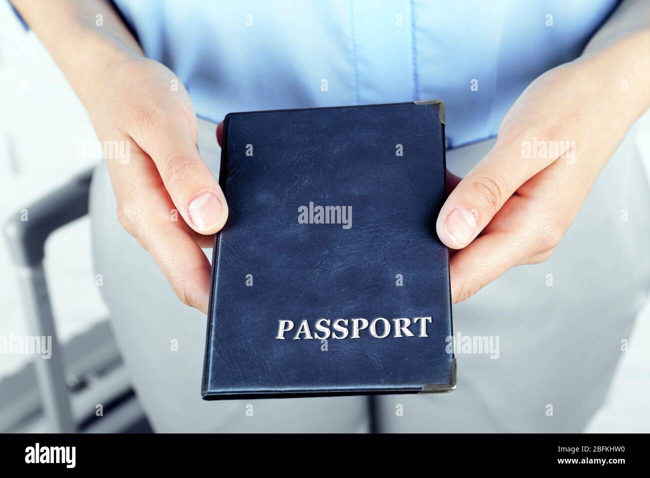 Hands holding passport hi-res stock photography and images - Alamy