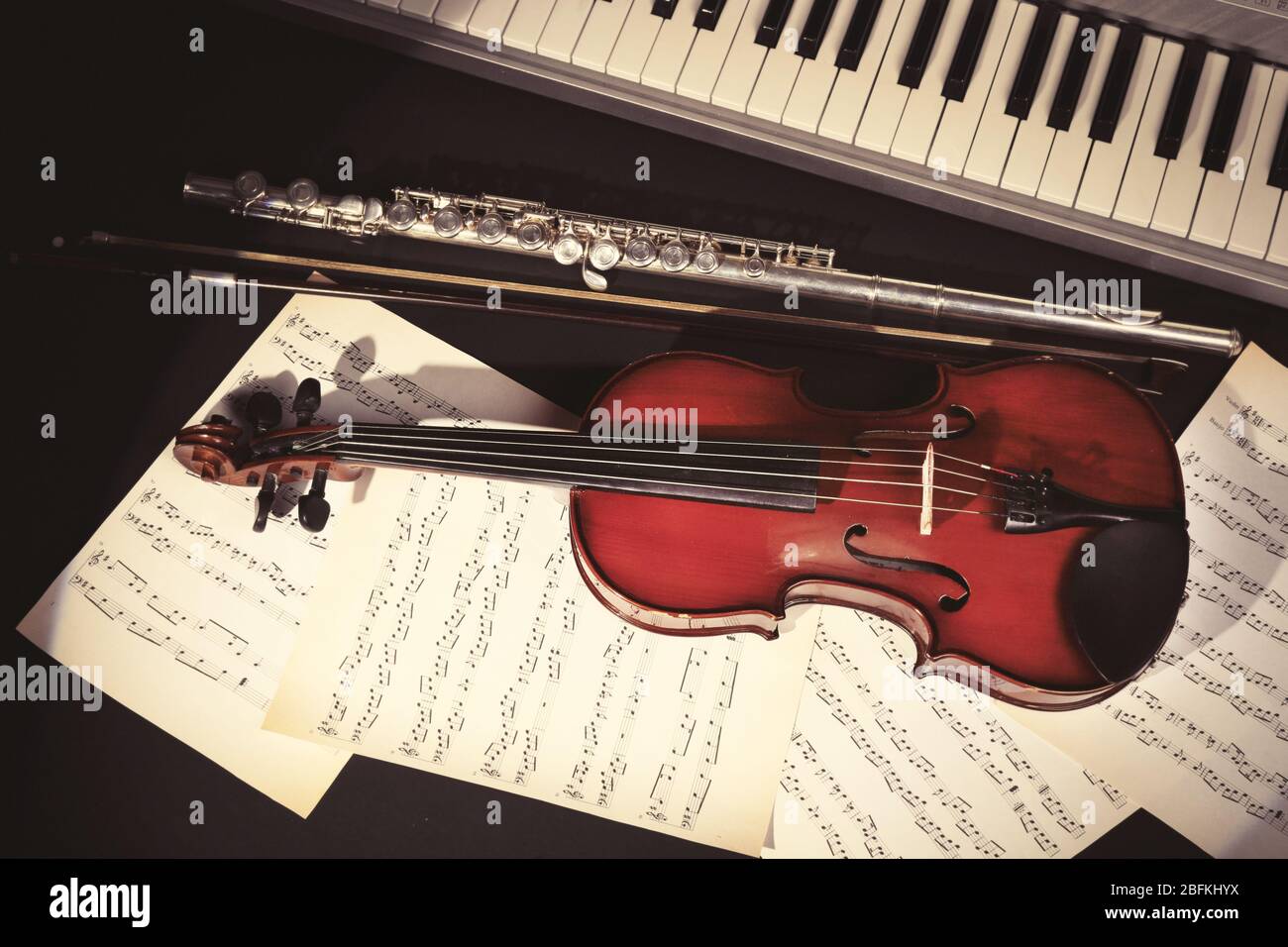 Musical instruments with music notes on dark background Stock Photo - Alamy