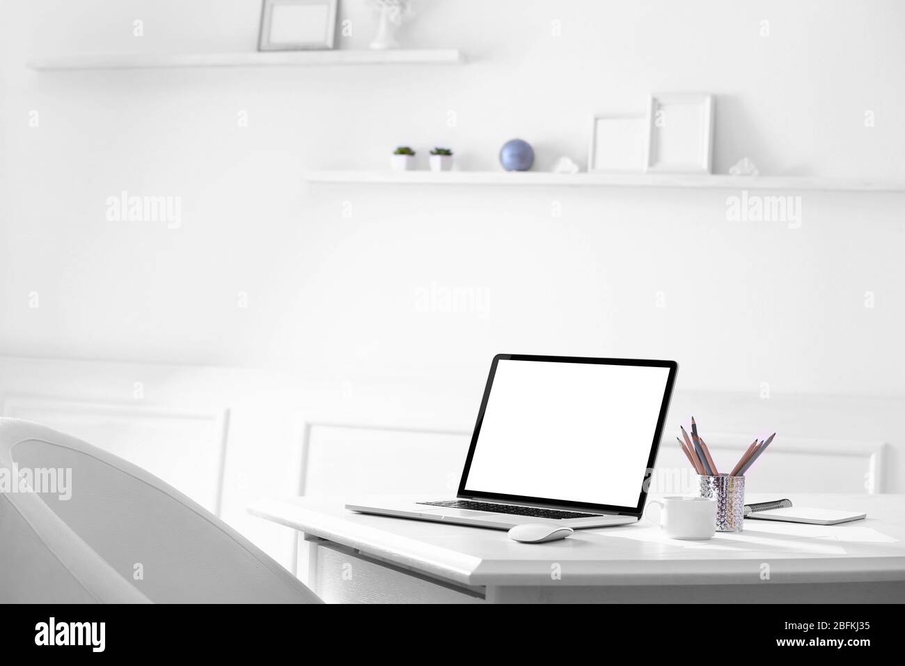 Workplace with laptop in room Stock Photo - Alamy