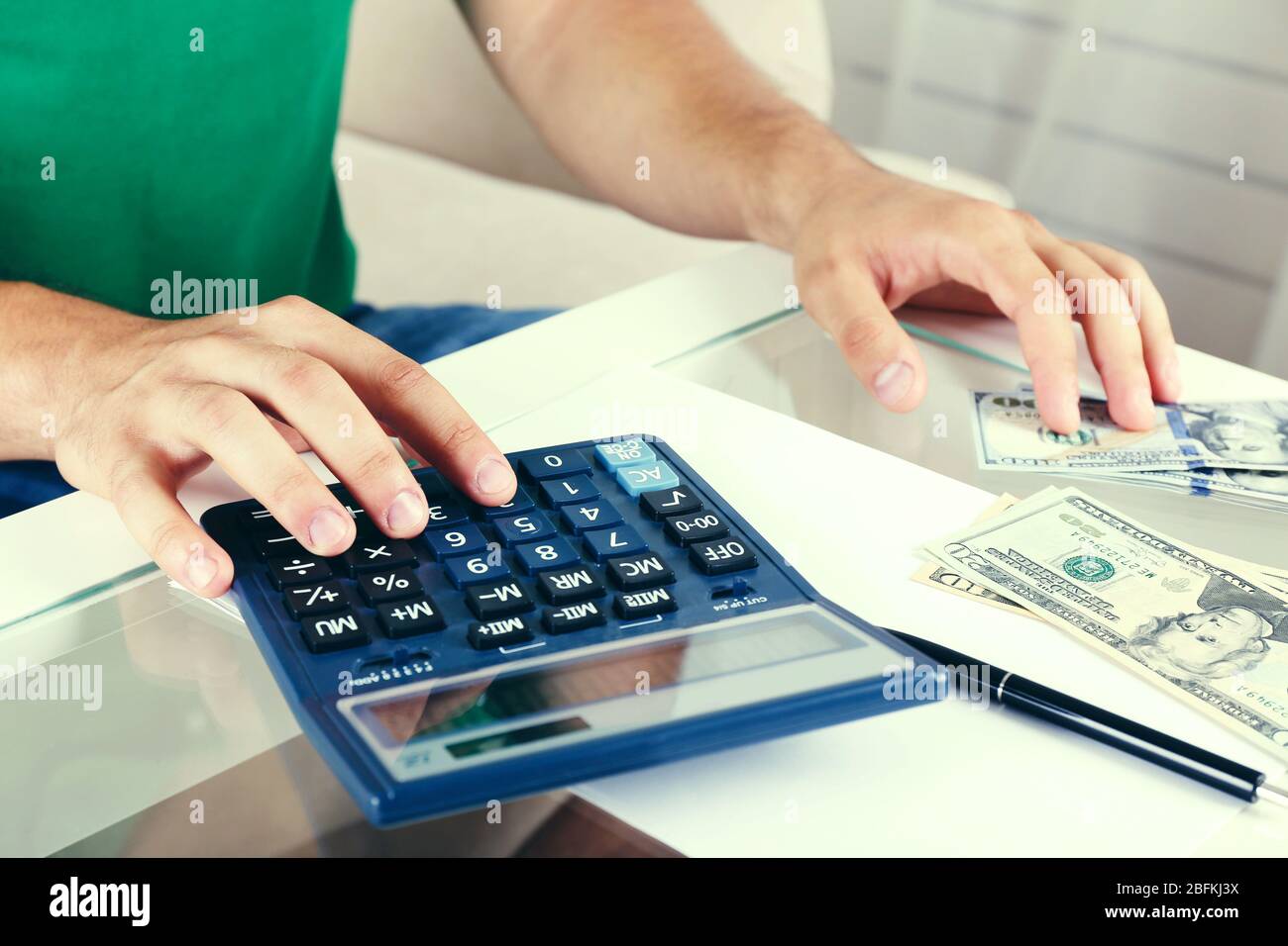 Calculating money, close up Stock Photo - Alamy