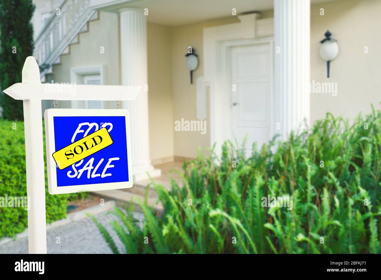 Real estate sign in front of new house for sale Stock Photo - Alamy