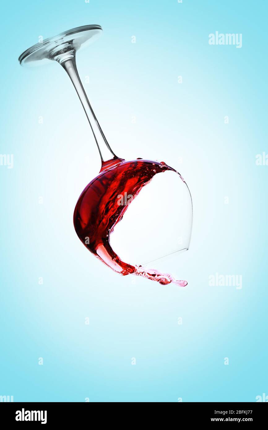 Falling glass of red wine Stock Photo - Alamy