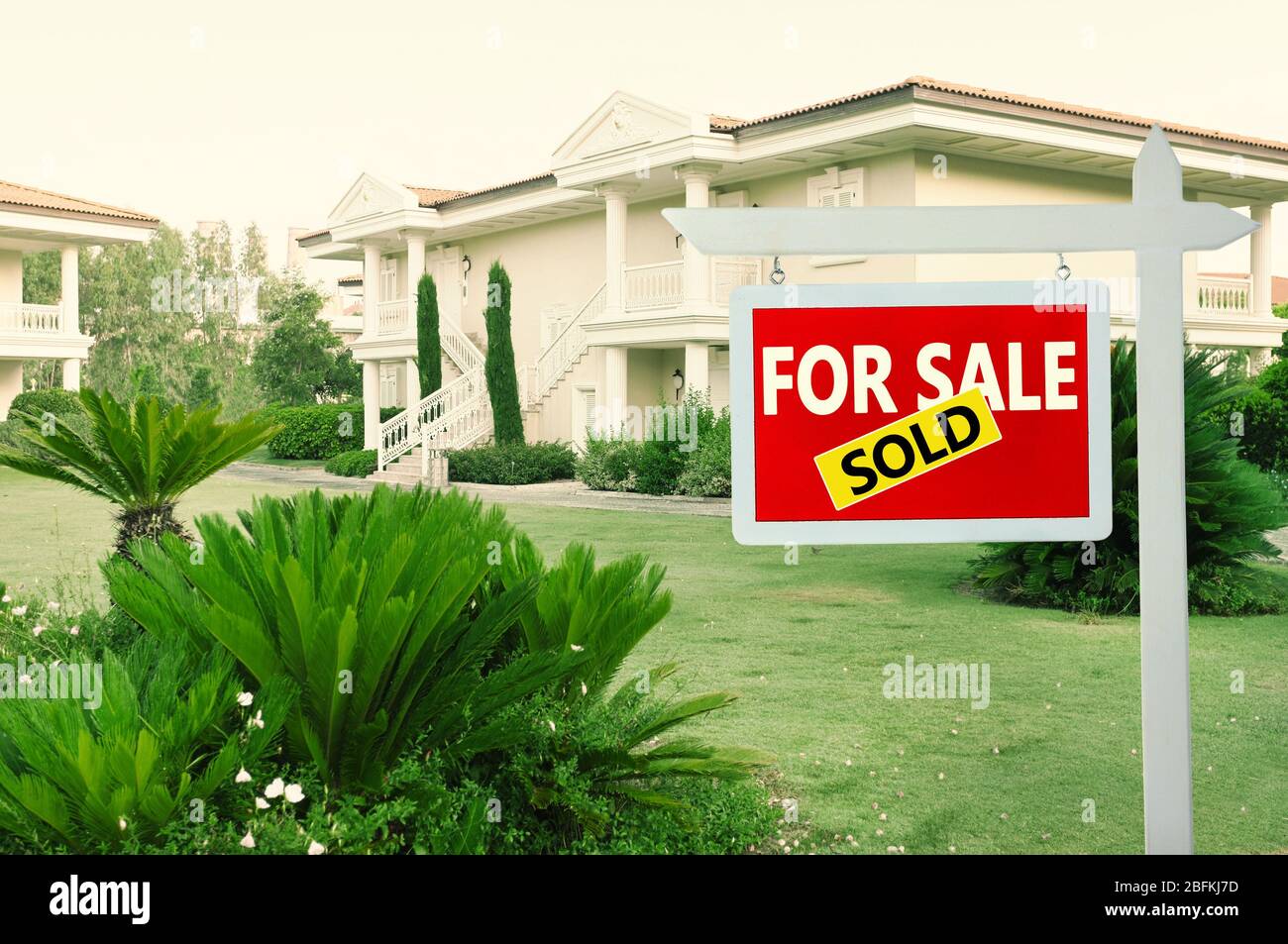 Real estate sign in front of new house for sale Stock Photo - Alamy