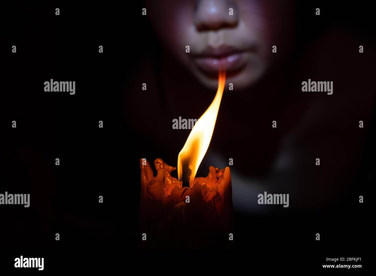 Face woman Blow out the candle at black background Stock Photo - Alamy