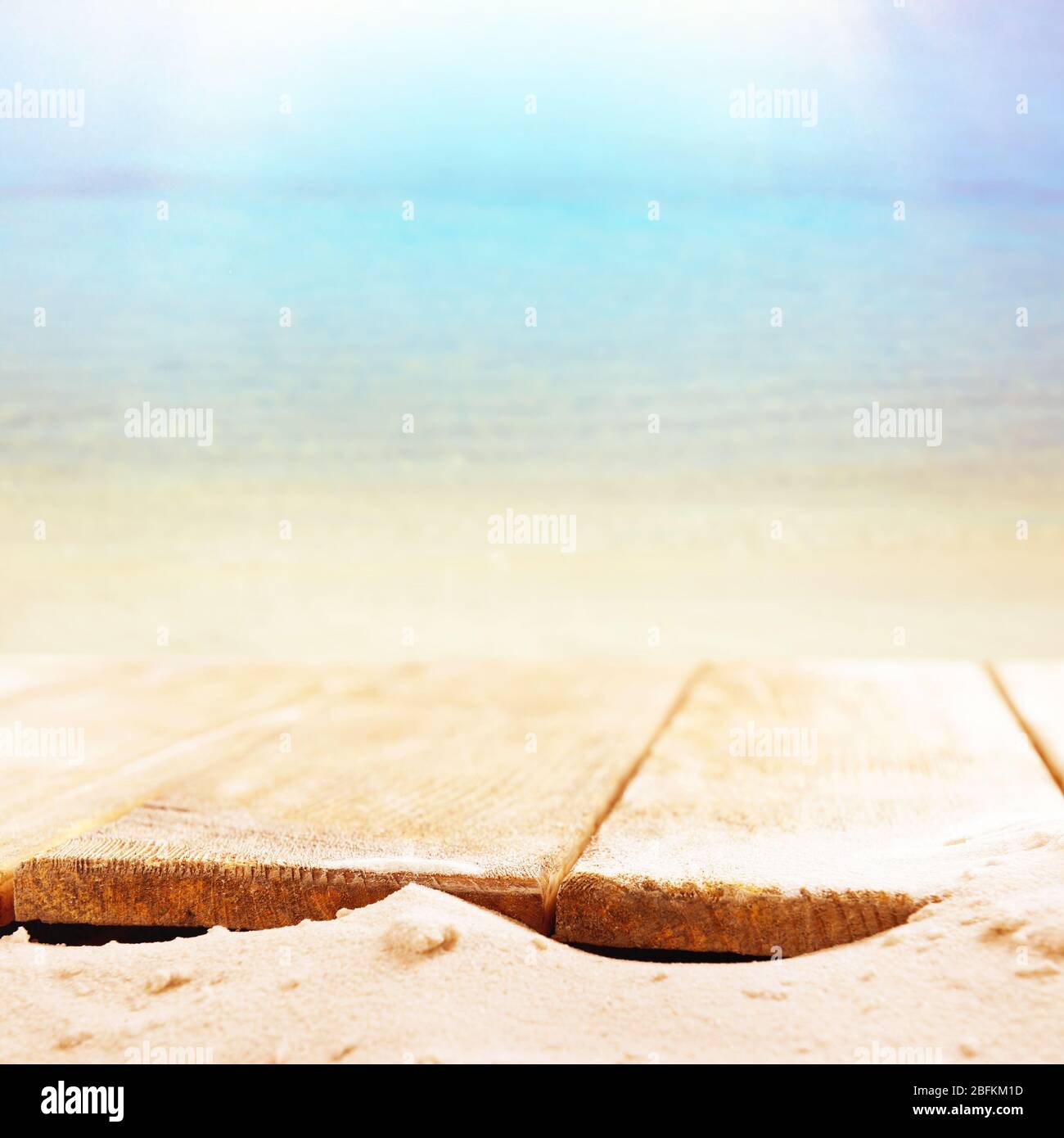 Sand with wooden planks on sea background Stock Photo - Alamy
