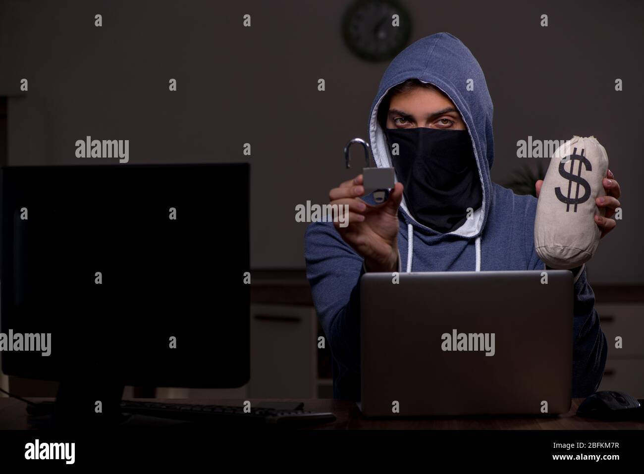 Male hacker hacking security firewall late in the office Stock Photo ...