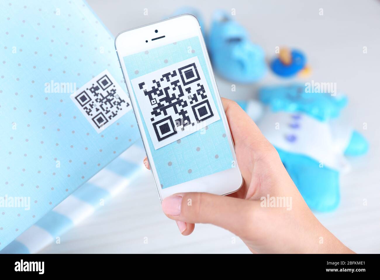Woman scanning voucher code with mobile phone close up Stock Photo - Alamy