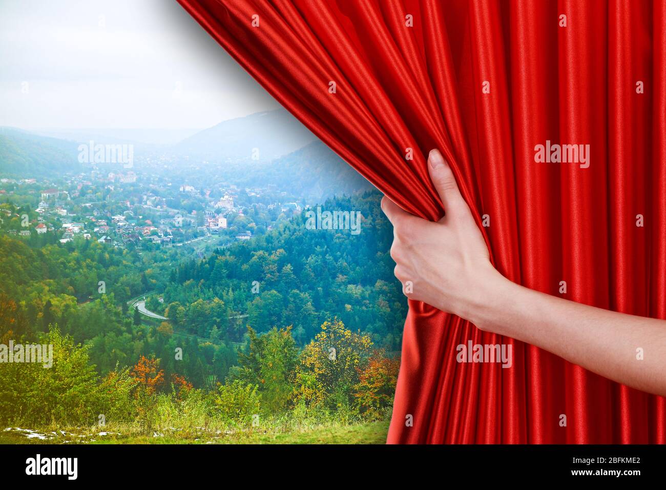 Human hand opens red curtain on nature background Stock Photo - Alamy
