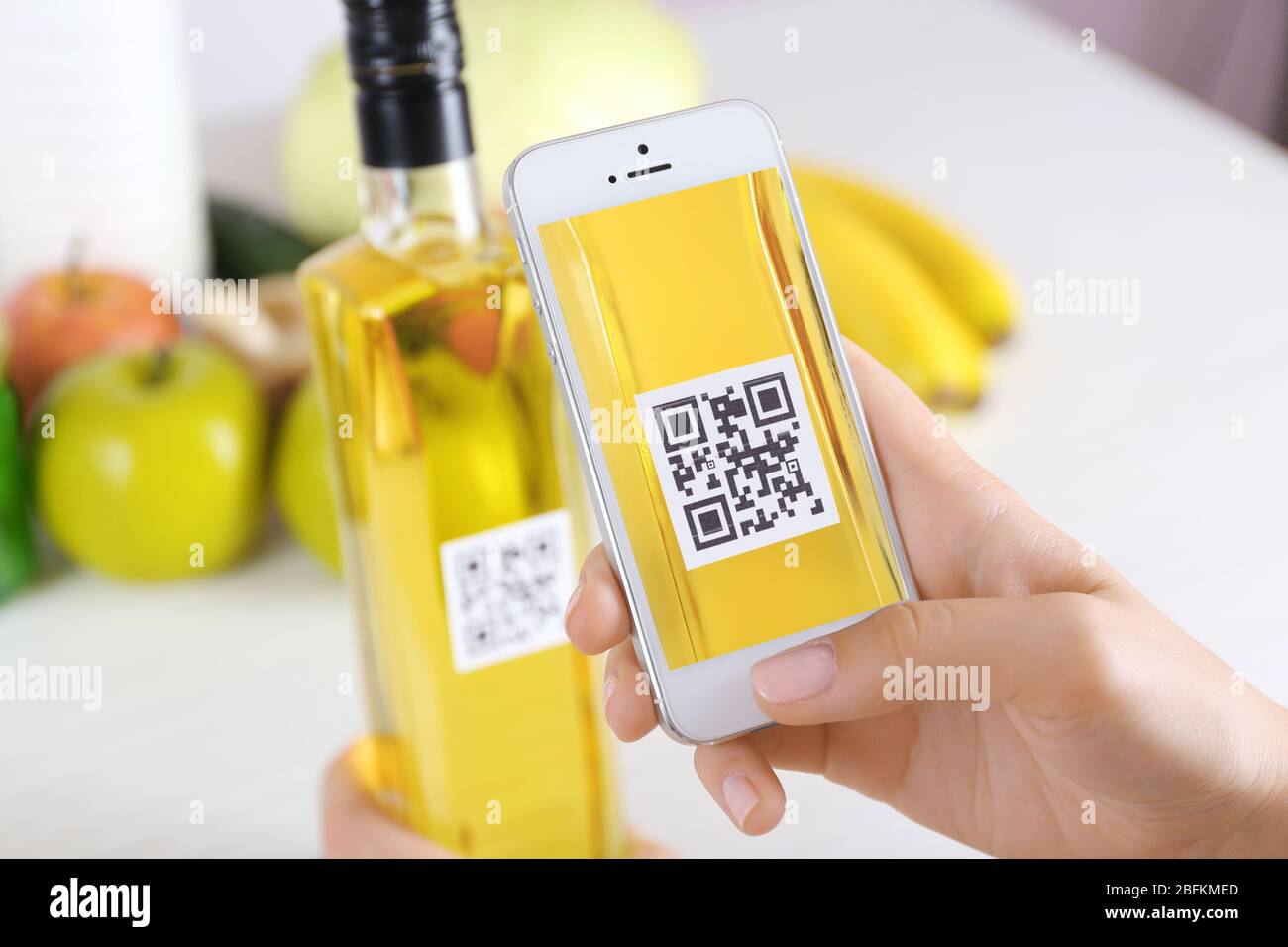 Woman scanning voucher code with mobile phone close up Stock Photo - Alamy