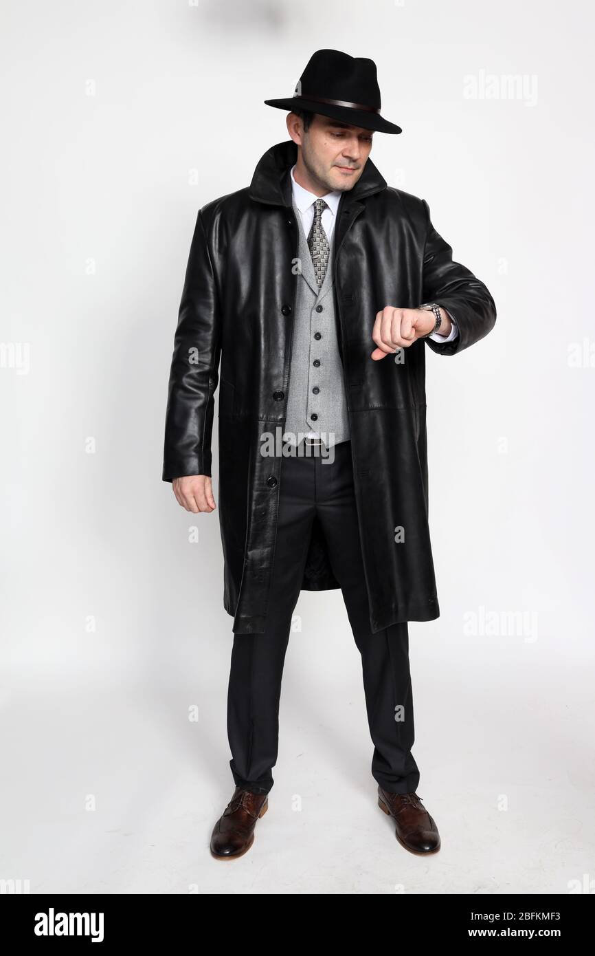 Handsome middle aged gangster man posing in studio on isolated ...