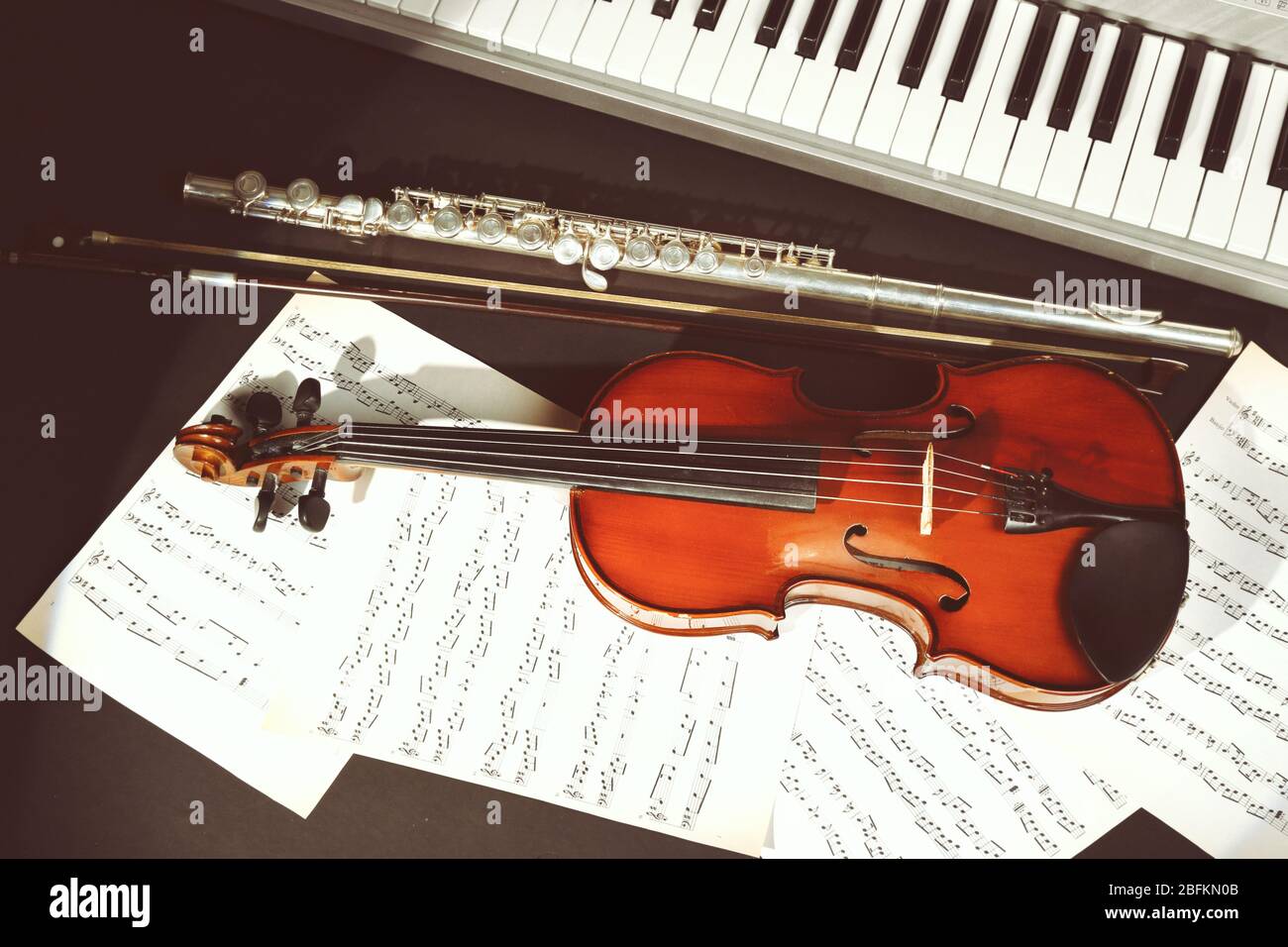 Musical instruments with music notes on dark background Stock Photo - Alamy