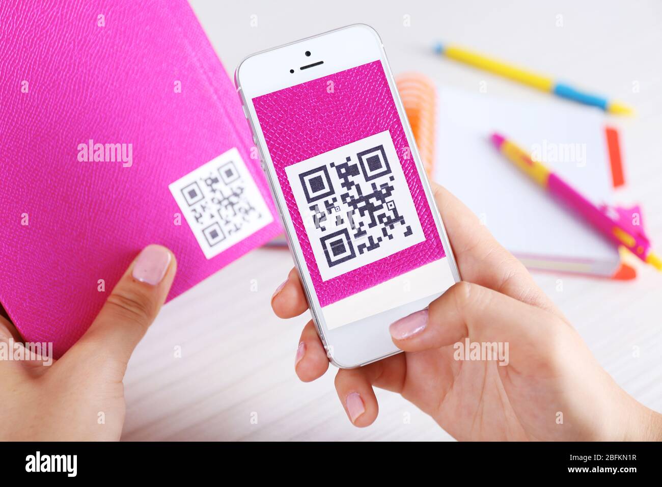 Woman scanning voucher code with mobile phone close up Stock Photo - Alamy