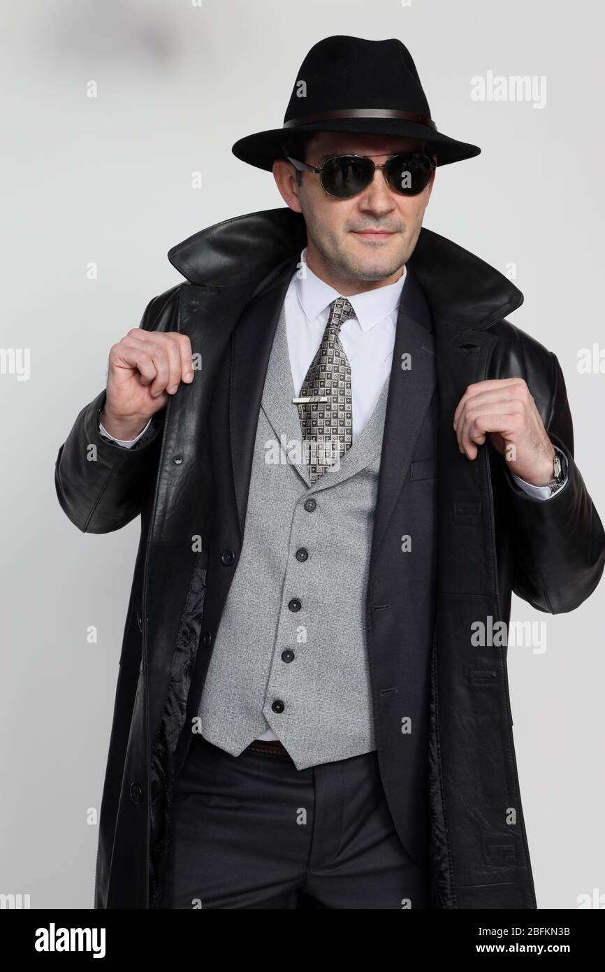 Handsome middle aged gangster man posing in studio on isolated ...