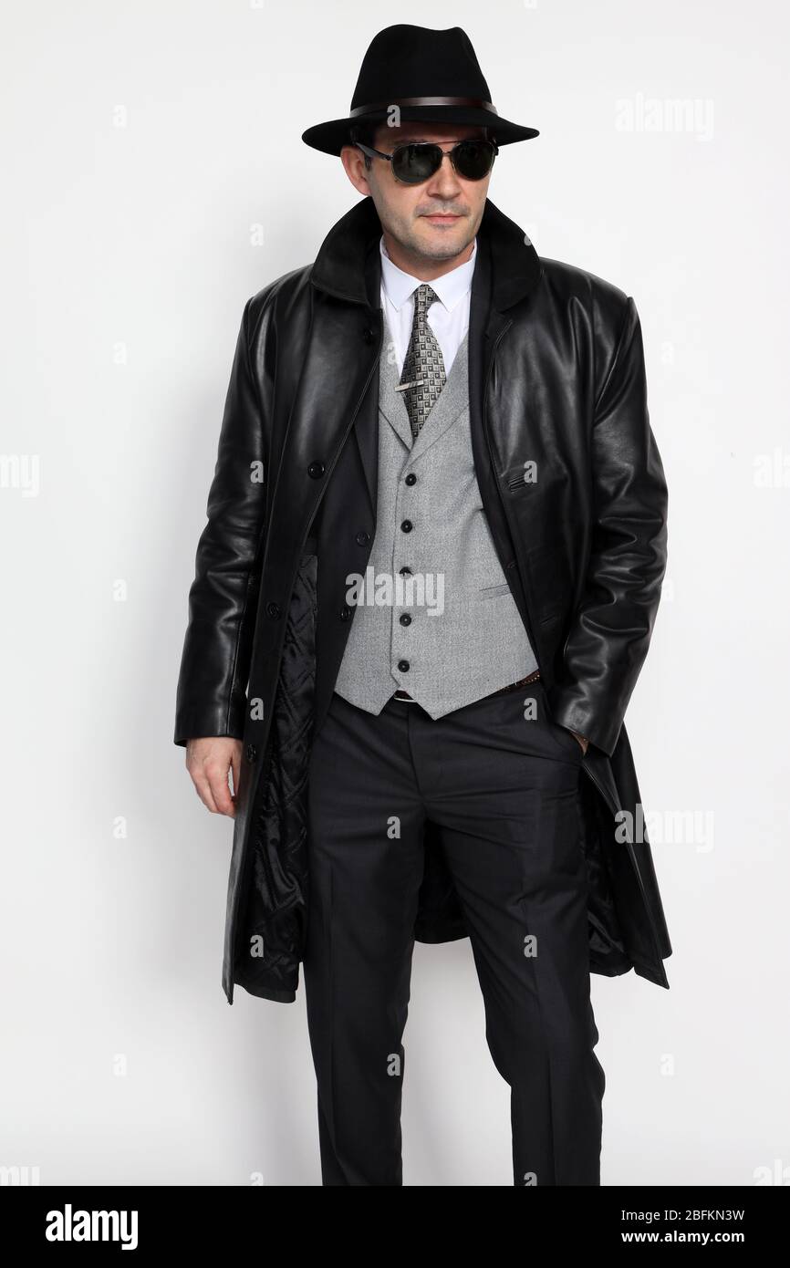 Handsome middle aged gangster man posing in studio on isolated ...