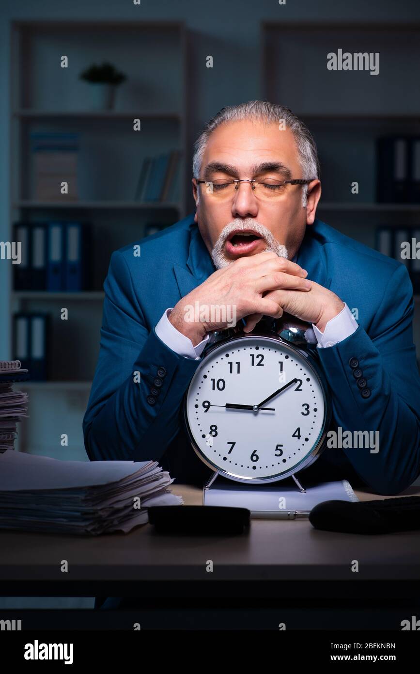 Old employee working late in the office Stock Photo - Alamy