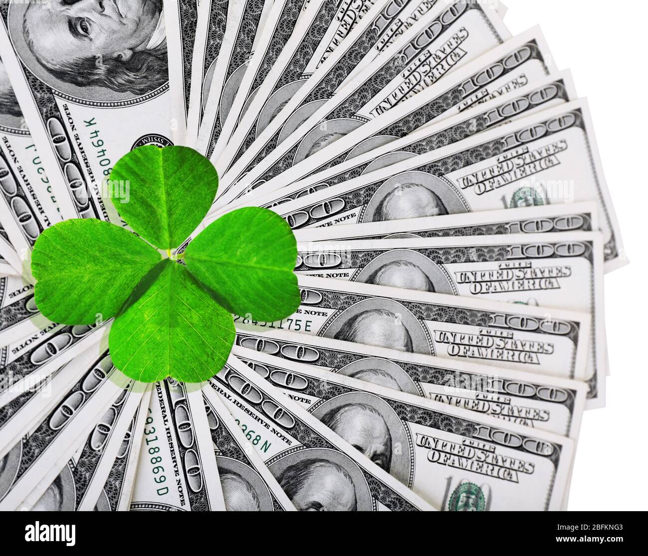 Clover leaf and dollars on white surface Stock Photo - Alamy