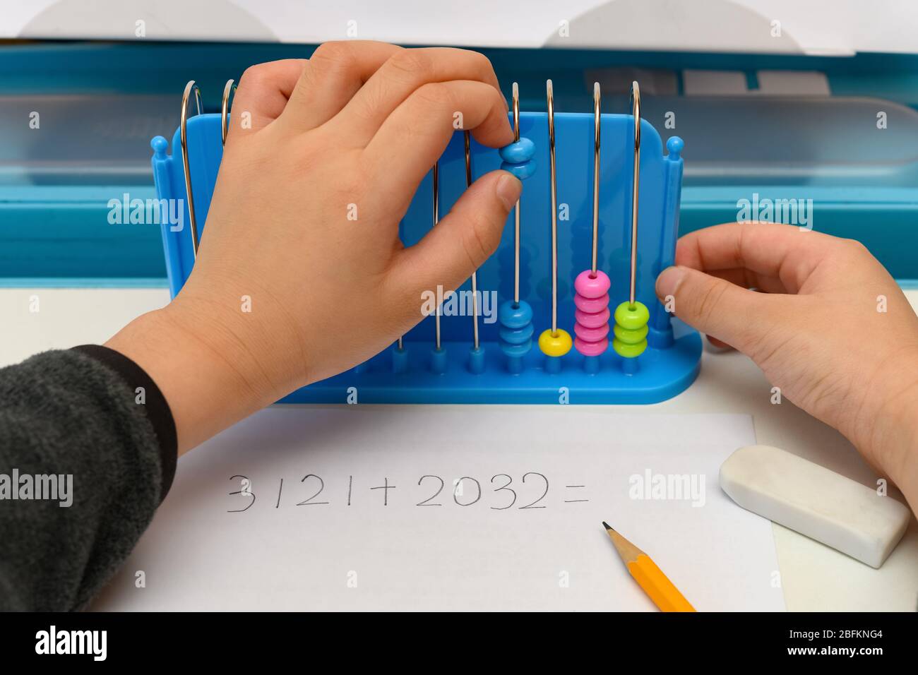 kid using abacus to calculate addition equation Stock Photo - Alamy