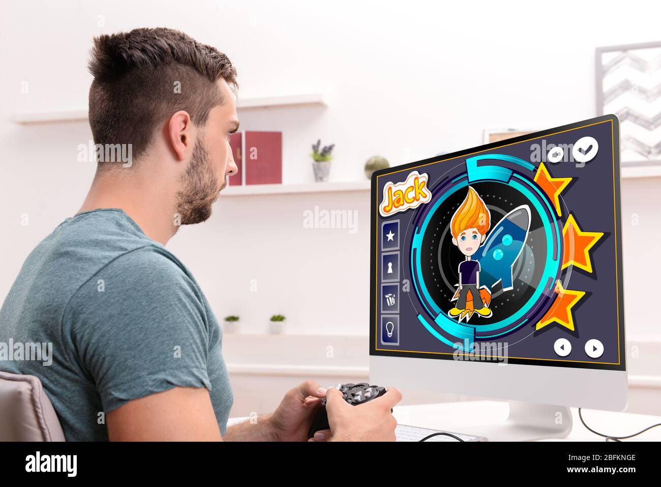 Young man playing computer games at home Stock Photo - Alamy