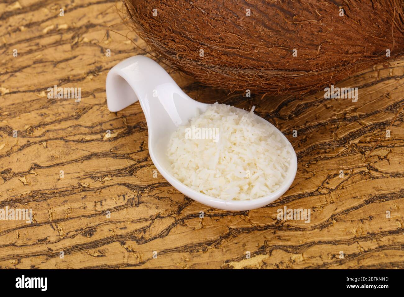 Coconut shredded chip with nut over wooden background Stock Photo - Alamy