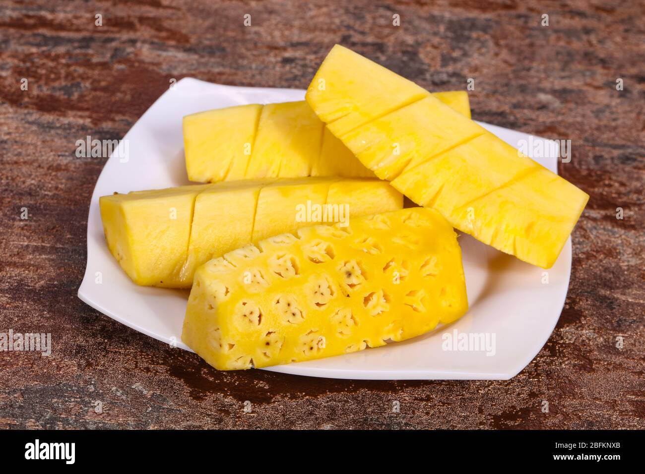Sliced sweet ripe tasty pineapple in the plate Stock Photo - Alamy