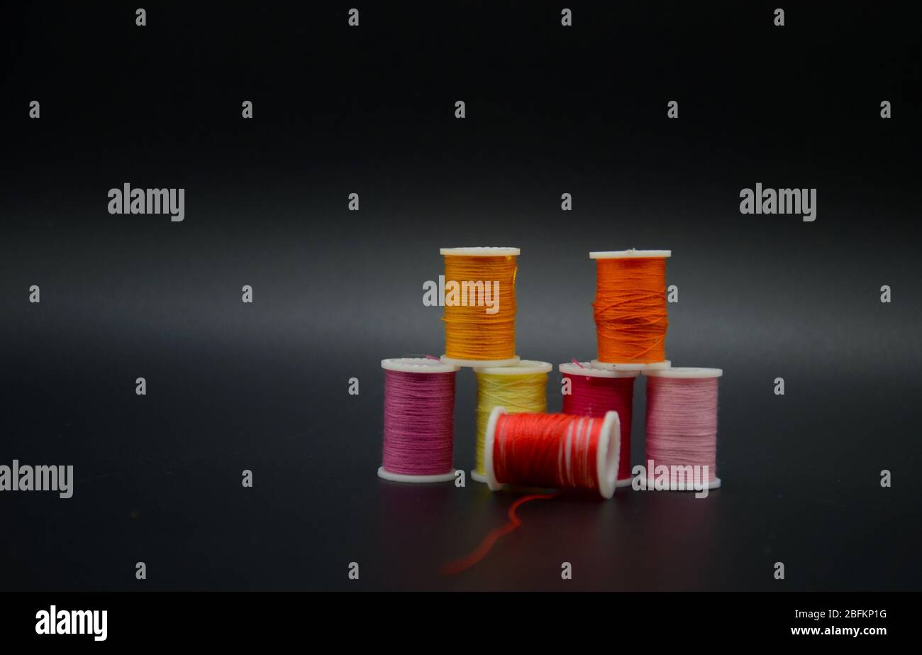 Cotton thread spool in various colors Stock Photo - Alamy