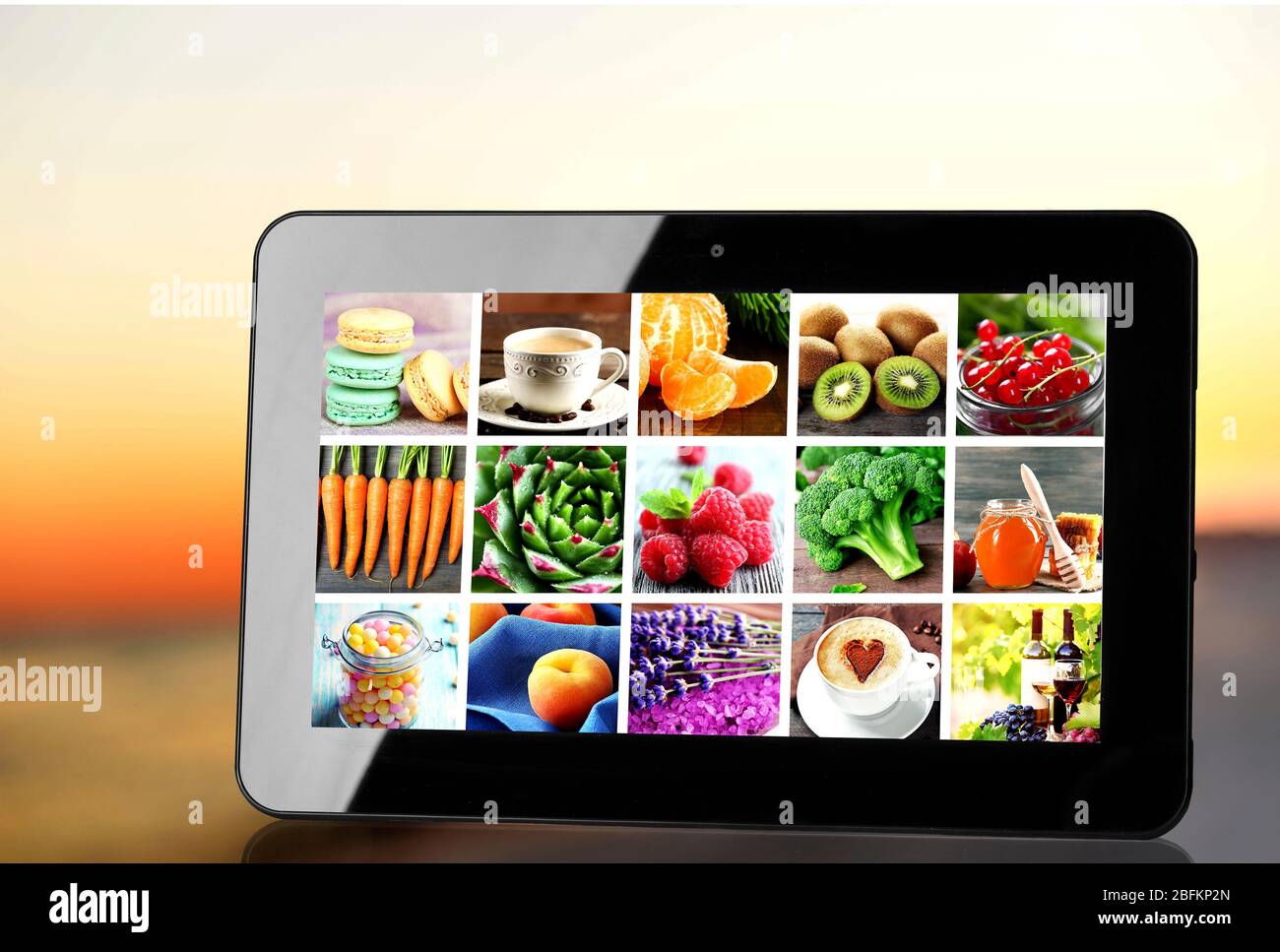 Tablet PC with images of natural objects, on light nature background ...