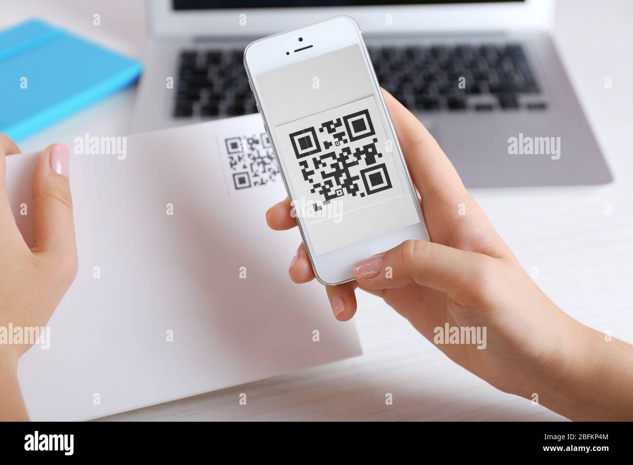 Woman scanning voucher code with mobile phone close up Stock Photo - Alamy