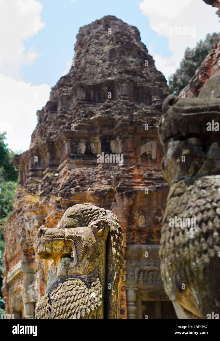 Ruined lion sculpture in front of old stupas, guarding the ancient ...