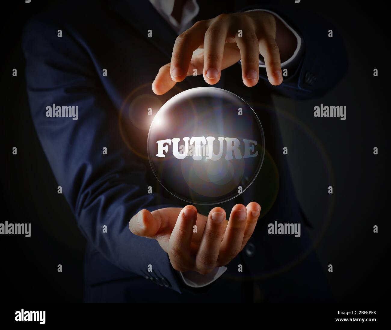 Future concept. Future word in transparent ball in hands on dark ...