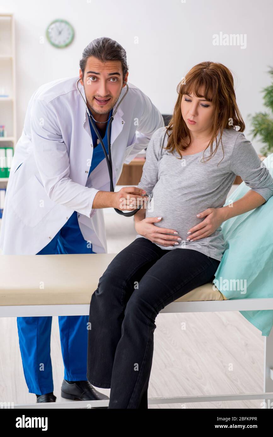 Young woman visting young male doctor Stock Photo - Alamy