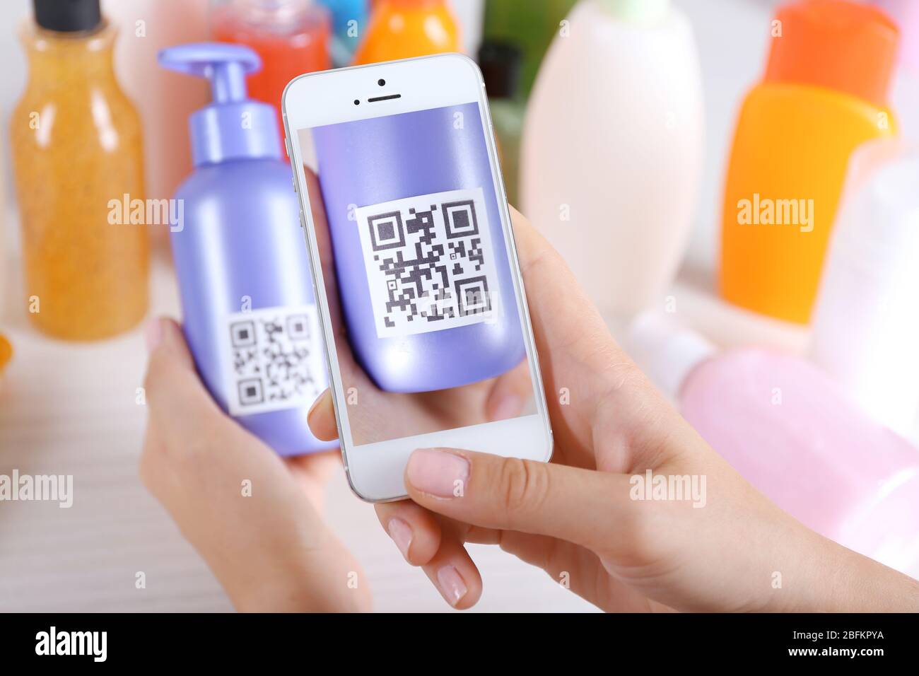 Woman scanning voucher code with mobile phone close up Stock Photo - Alamy