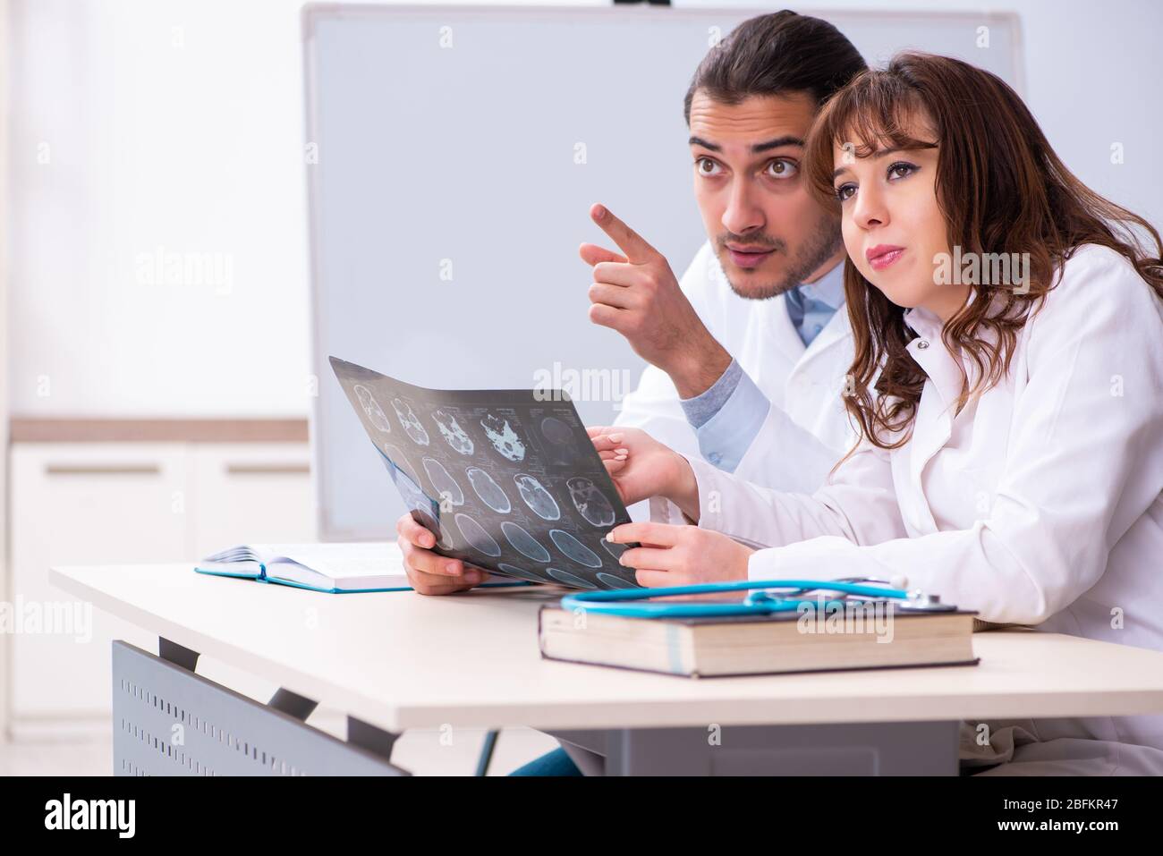 Young male doctor radiologist and female student in the classroom Stock ...
