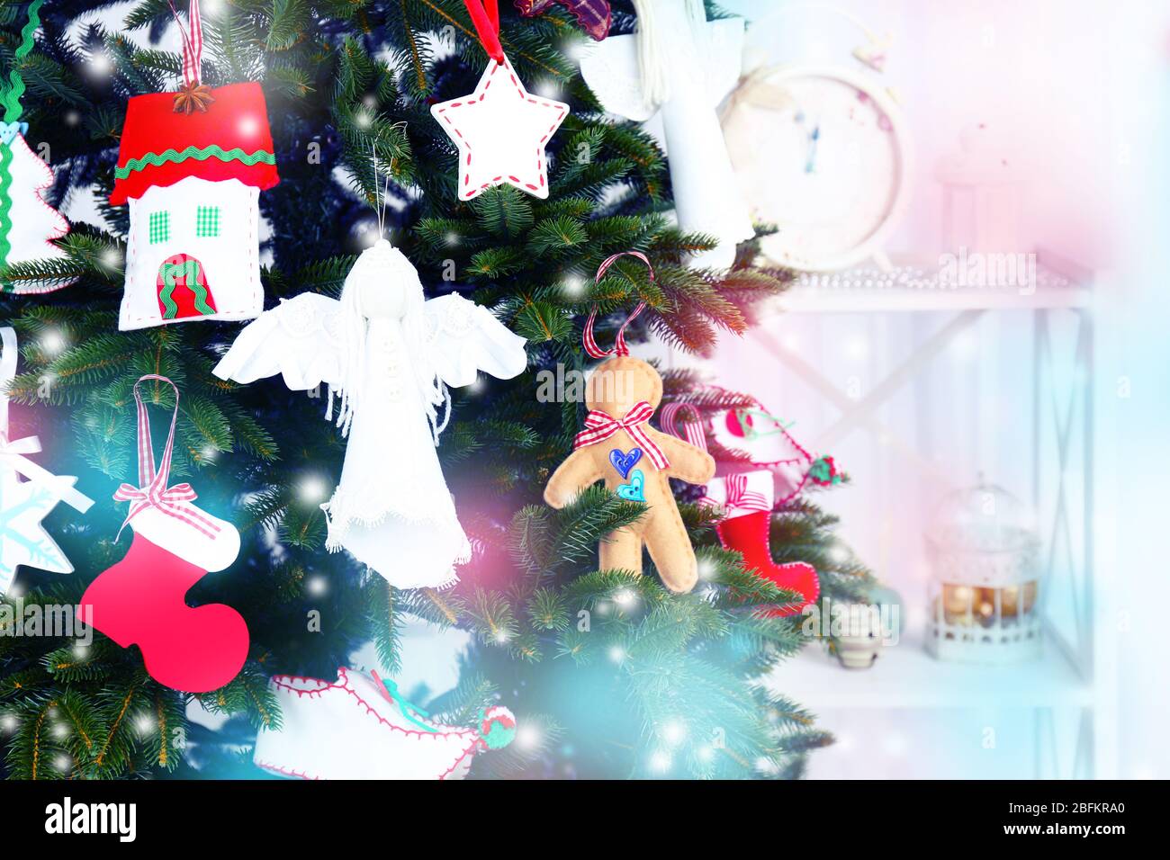 Christmas handmade decorations on Christmas tree on light background ...