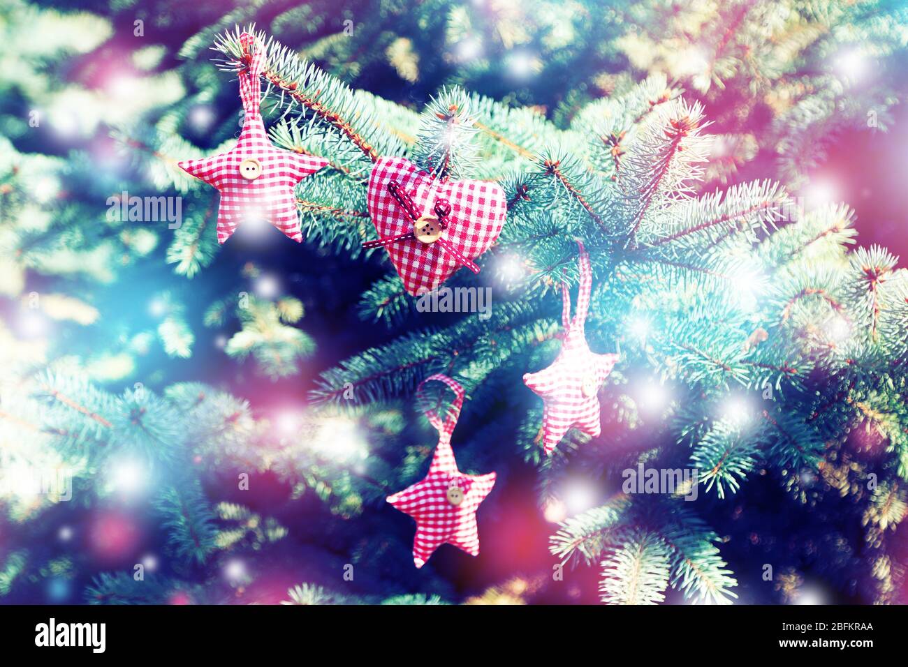 Christmas toys on fir tree branch, outdoors Stock Photo - Alamy