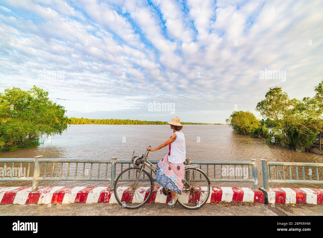Tourist riding bicycle in the Mekong Delta region, Ben Tre, South ...